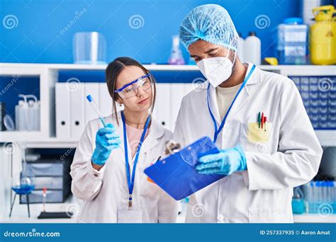 Man And Woman Scientists Holding Test Tube Writing On Document At Laboratory Stock Image Image