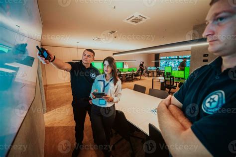 Group Of Security Data Center Operators Working In A Cctv Monitoring
