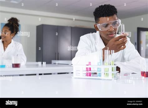 Teenage Biracial Babe And Girl Conduct An Experiment In A High Babe Lab Dressed In Lab Coats