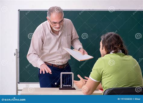 Old Professor Physicist And Young Student In The Classroom Stock Image