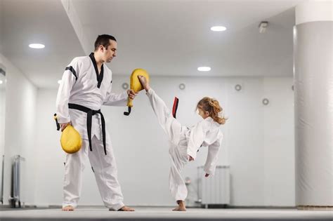 Premium Photo A Taekwondo Girl Is Practicing Kick On Kick Pads With