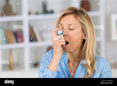 Woman With Asthma Using An Asthma Inhaler Stock Photo Alamy