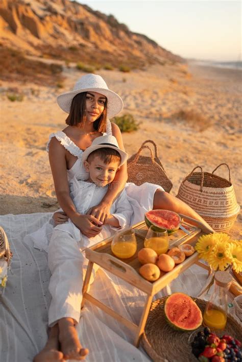 Mother And Son Enjoying A Beach Picnic At Sunset Stock Image Image Of Natural Getaway