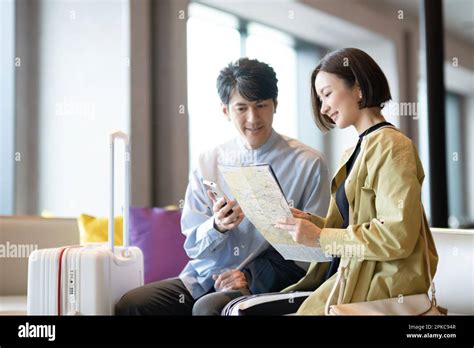 Men And Women Checking Travel Plans Stock Photo Alamy