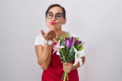 Middle Age Brunette Woman Wearing Apron Working At Florist Shop Holding