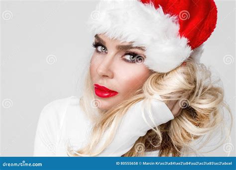 Beautiful Blonde Female Model Dressed As Santa Claus In A Red Cap Stock