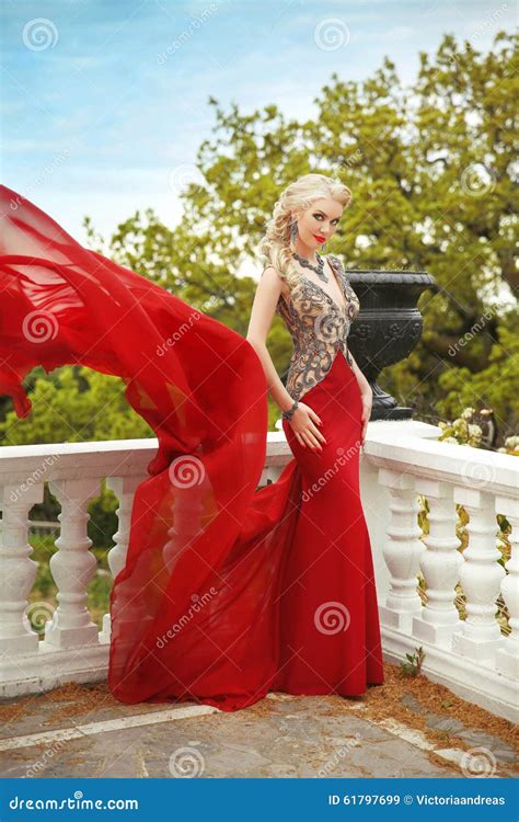 Fashion Beauty Outdoor Portrait Of Beautiful Woman In Red Dress Stock