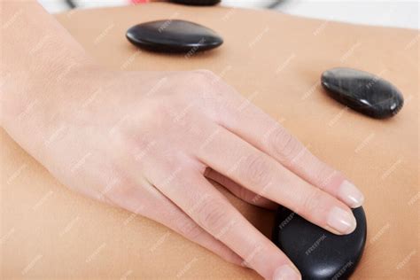 Premium Photo Cropped Hands Of Female Massage Therapist Giving Lastone Therapy To Customer