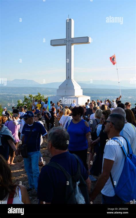 Pilgrims On An Early Morning Around The White Cross On The Top Of Mount