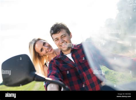 Beautiful Young Couple In Love Enjoying A Quad Bike Ride In Countryside