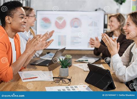 Close Up Of Multiracial Women Clapping In Hands While Sitting Together