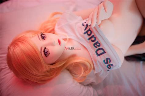 Busty Blonde Sex Doll In Stockings Belle Posing Handcuffed In A Cage