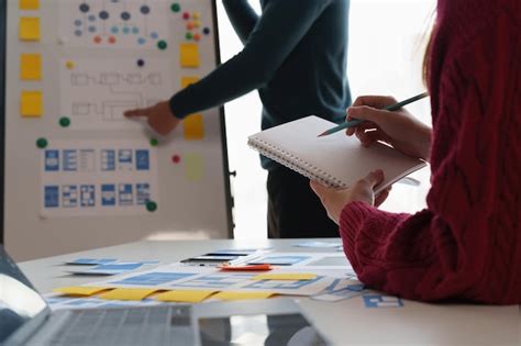 Premium Photo Group Of Ux Developer And Ui Designer Brainstorming About App Interface Design