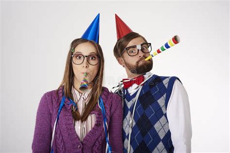 Nerd Couple Surprised Nerd Couple Sitting On The Bed And Looking At Camera Stock Image Image