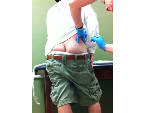 Two Injections And Two Band Aids In Buttocks