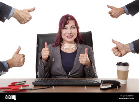 Happy Woman Sitting At Her Desk With Her Thumbs Up With A Mans Thumb Up