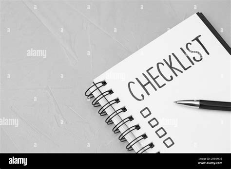 Notebook With Inscription Checklist On Light Grey Table Top View