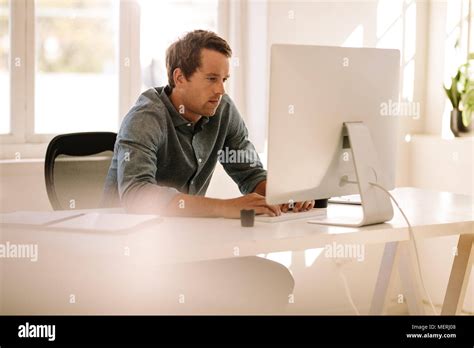 Businessman Working On Computer Man Sitting At His Work Table Working On Computer At Home Stock