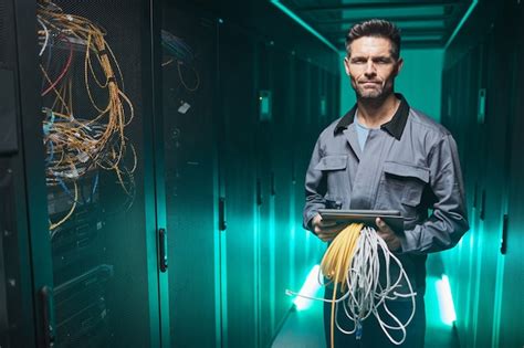 Premium Photo Waist Up Portrait Of Mature Network Engineer Looking At Camera And Using Digital