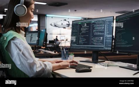 Female Asian Game Programmer Coding On Desktop Computer In Game