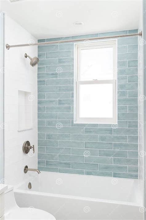 A Bathroom Shower With Blue And White Subway Tiles Stock Image Image