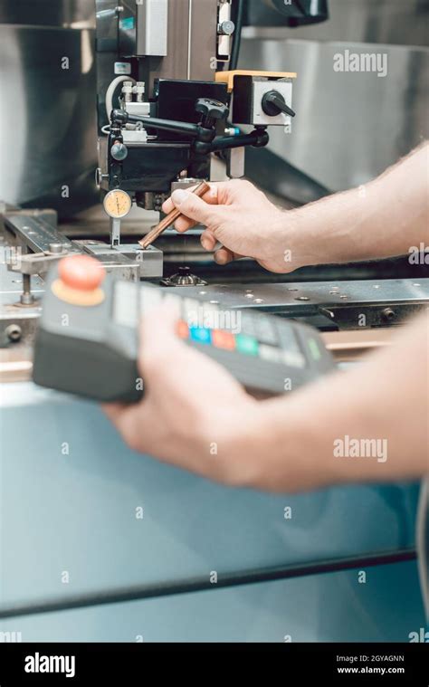 Close Up Of Worker In Factory Putting Tool Into A Punching Machine Stock Photo Alamy