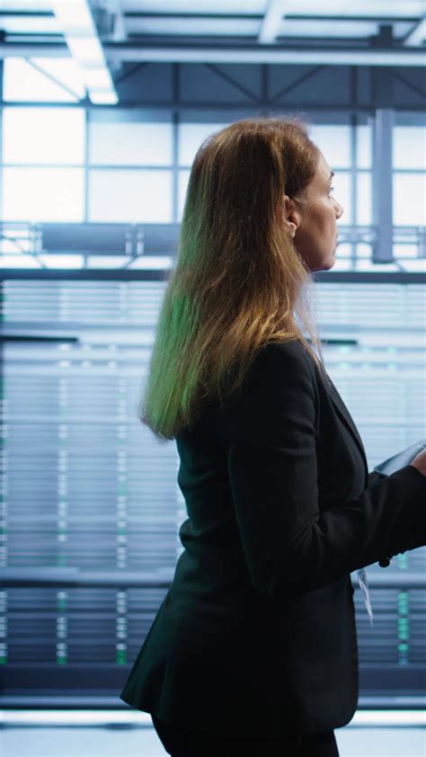 Vertical Engineer In Server Hub Checking Recovery Plan On Tablet Monitoring Rackmounts Energy