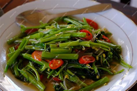 Premium Photo Tumis Kangkung Sauteed Kale On A Ceramic Plate Water