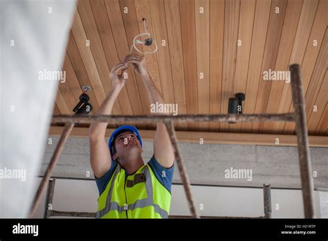 Electrician Fixing Cable At Ceiling Stock Photo Alamy
