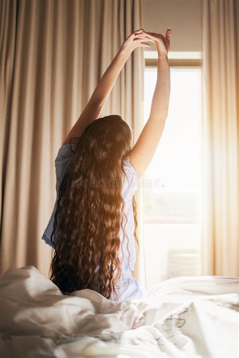 Morning Wake Up And A Woman Stretching In The Bedroom Of Her Home After Sleeping Or Rest On The