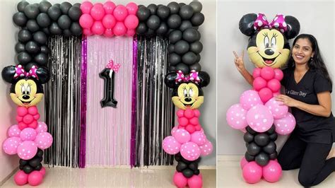 The Balloon Arch Is Decorated With Minnie Mouse Balloons