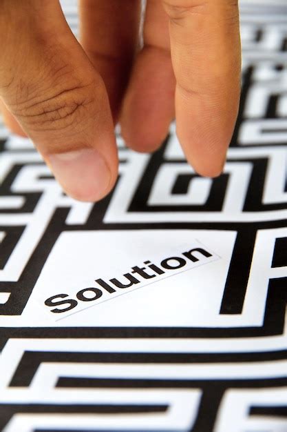 Premium Photo Cropped Hand On Maze Paper With Solution Text