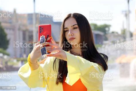 긴 머리와 거리에 서있는 스마트 폰 카메라에서 셀카를 찍는 완벽한 메이크업을 가진 매력적인 소녀 18 19세에 대한 스톡 사진 및 기타 이미지 Istock