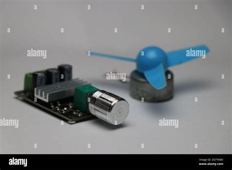 DC Motor Pwm Speed Controller Board And Dvd Motor With Fan On Background Stock Photo Alamy
