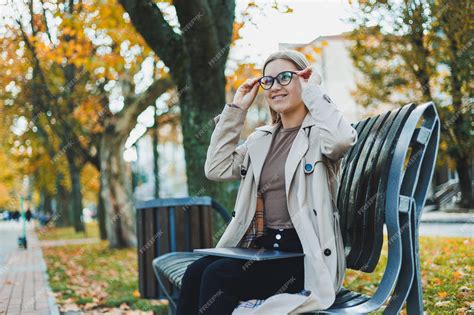 Premium Photo A Business Woman Works With A Laptop In Autumn Park She Has A Great Smile Long