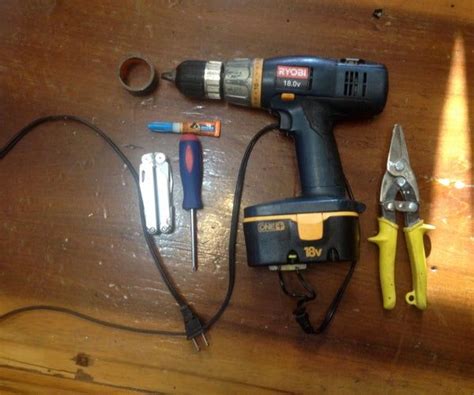 Some Tools Are Laying Out On A Wooden Table With One Cordless Drill Two Screwdrivers And The Other
