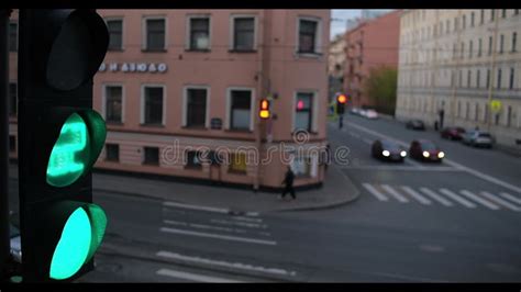Red Light Signals Vehicles To Stop At An Intersection While Pedestrians