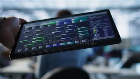 computer scientist in data center solving tasks on tablet stock image