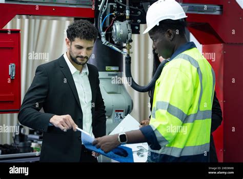 Technicians Are Introducing Industrial Hand Robots To Businessperson Of
