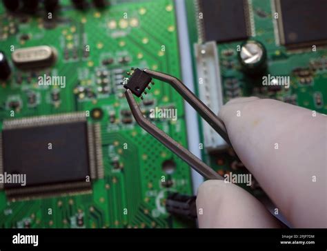 Surface Mount Chip Removed From The Board Microchip Inserting Onto An Electronic Card Stock