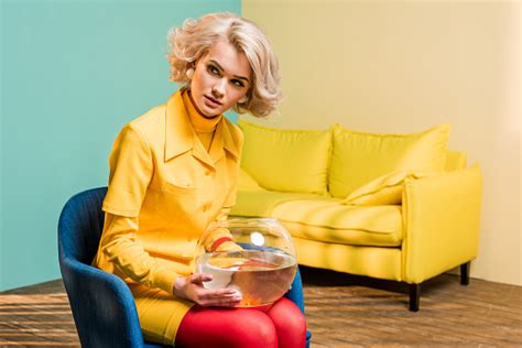 황금 물고기 수족관 화려한 아파트 인형 집 개념에의 자에 앉아 있는 복고풍 스타일 의류에 젊은 여자 감금 상태에 대한 스톡 사진 및 기타 이미지 Istock