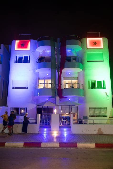 Illuminated Building With Moroccan Flags And Colorful Facade Lighting At Night Editorial Stock