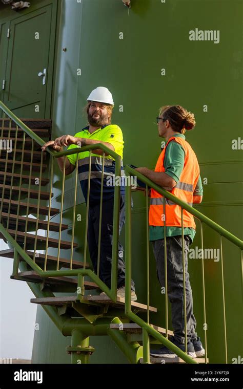 Two Professional Inspectors One Visibly Disabled Evaluate Safety