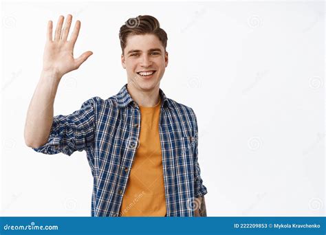 Portrait Of Friendly Smiling Man Waving Raised Hand Saying Hello And Looks Happy Greeting You
