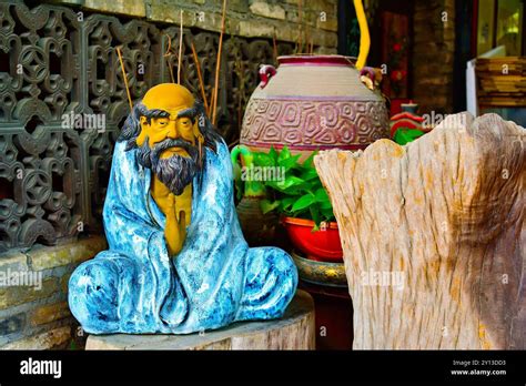 Clay Pottery Sculpture Of A Bearded Chinese Monk In A Blue Robe