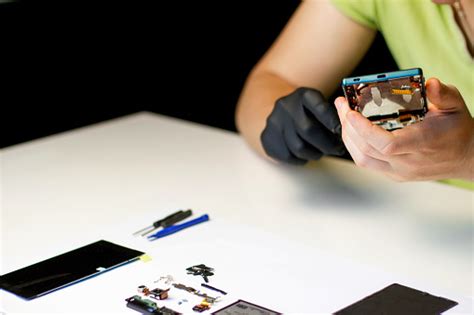 수리 공 실험실에서 스마트폰의 마더보드를 수리하는 디포커스 기술자 휴대 전화 전자 수리 업그레이드 및 기술 깨진 스마트 폰