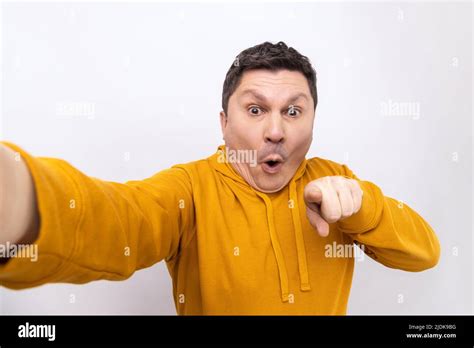 Portrait Of Shocked Man Blogger Pointing At You Looking At Camera With