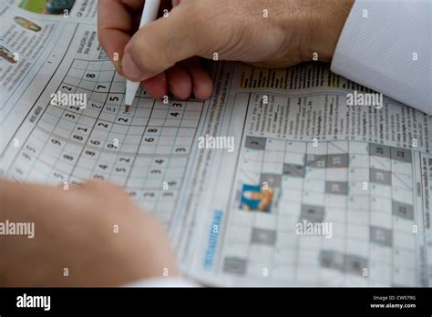 Close Up Of A Man Solving A Sudoku Puzzle Stock Photo Alamy