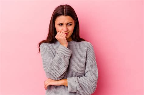 Premium Photo Young Indian Woman Isolated On Pink Wall Biting