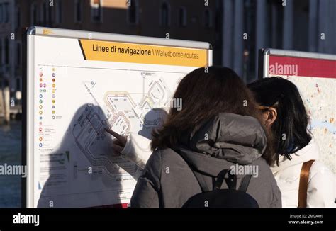 Two Female Tourists Read The Navigation Map While Choosing Route